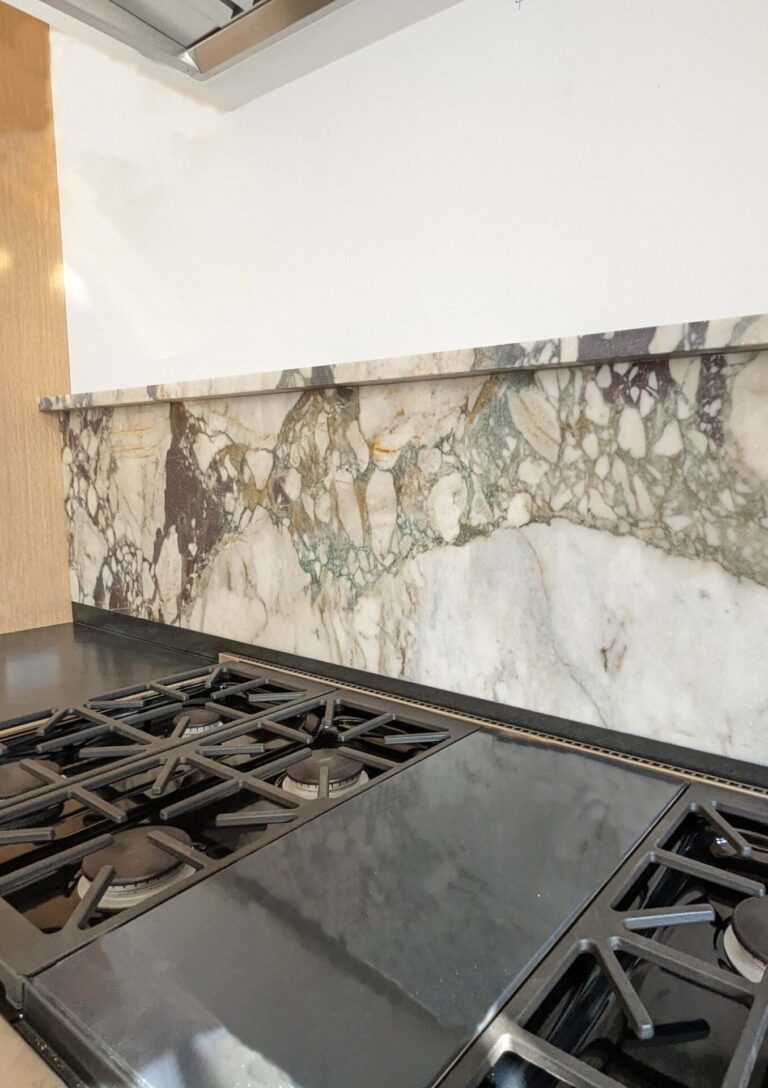 Step Up Your Slab Backsplash With a Ledge - Normandy Remodeling